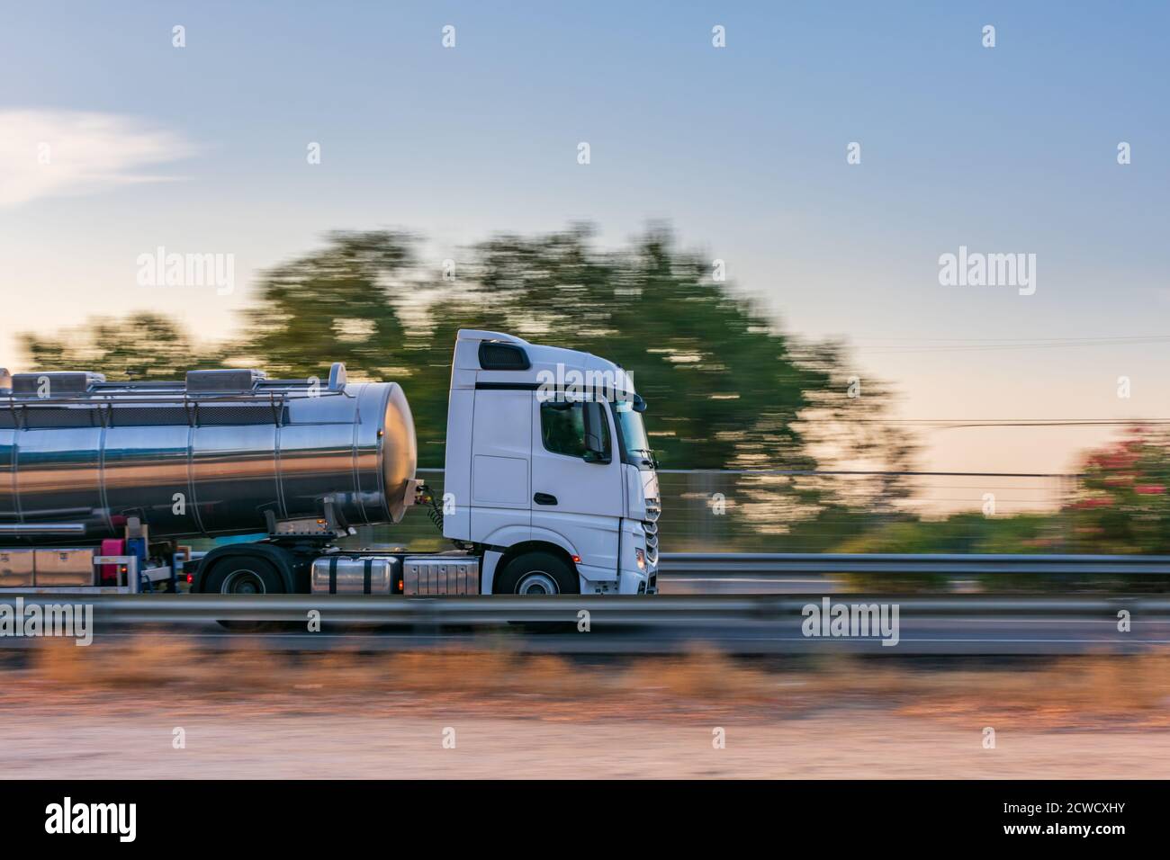 Tank truck driving fast on the highway Stock Photo - Alamy