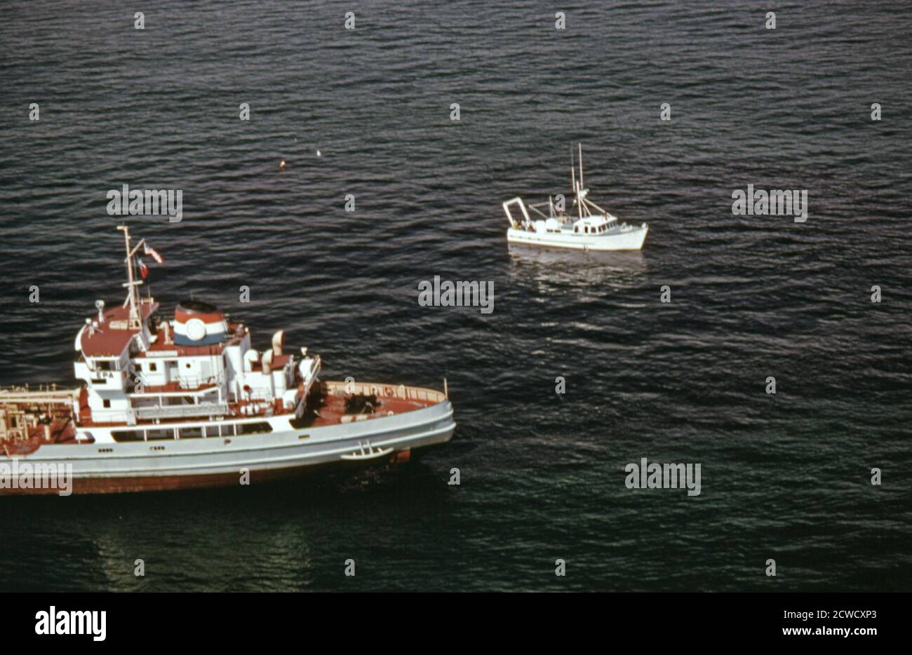 NOAA ship background takes water samples as a New York city sludge ...
