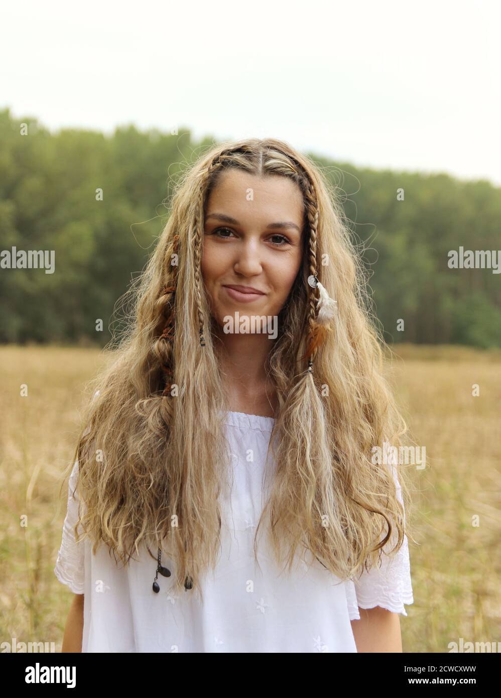The young girl poses in the field Stock Photo - Alamy