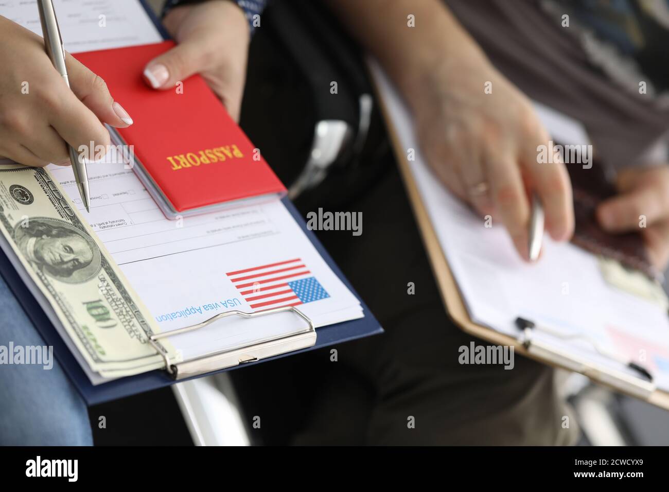 Man and woman are holding folder with application for visa and dollars ...