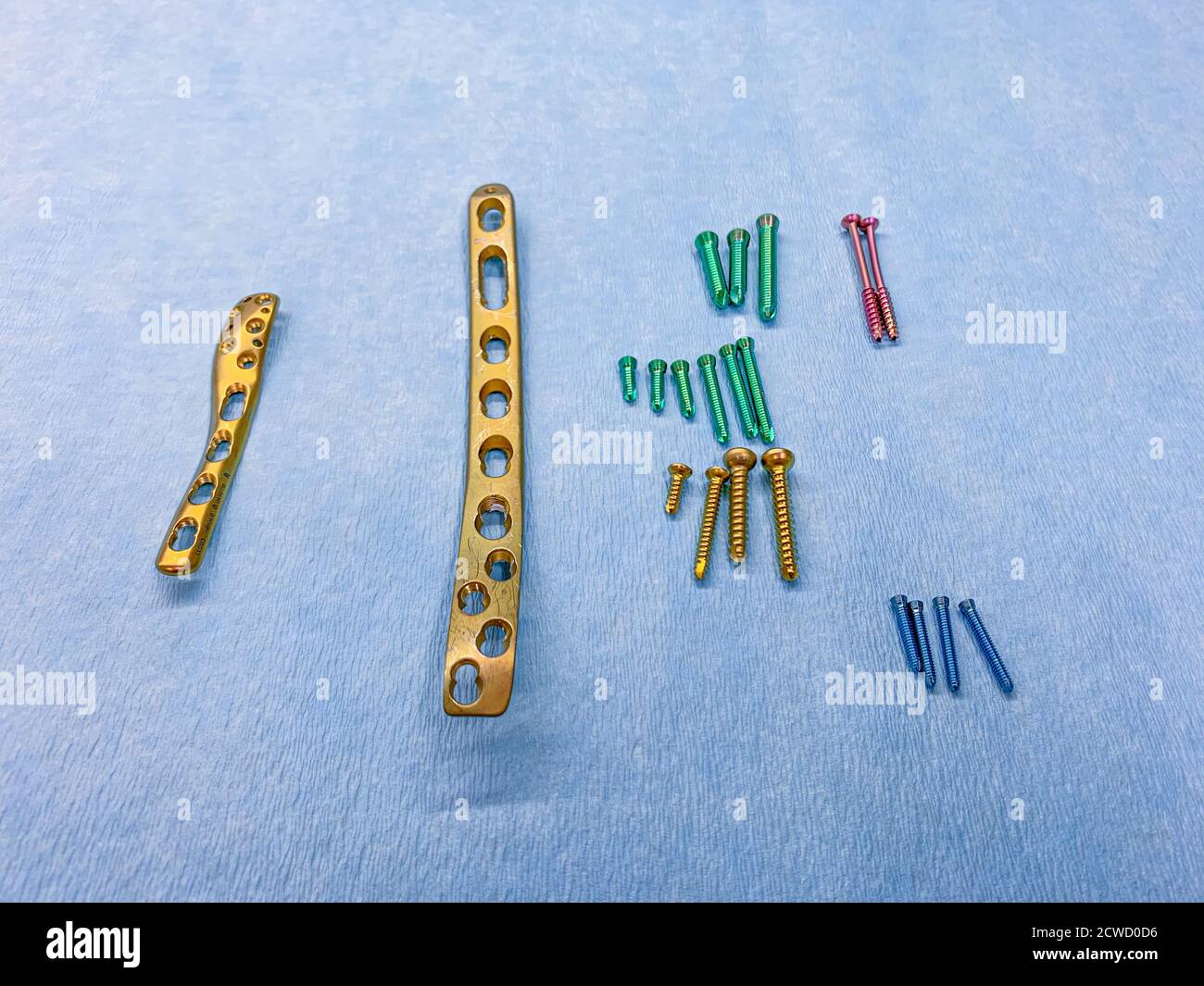 explanted titanium screws and titanium plates in different colors and ...
