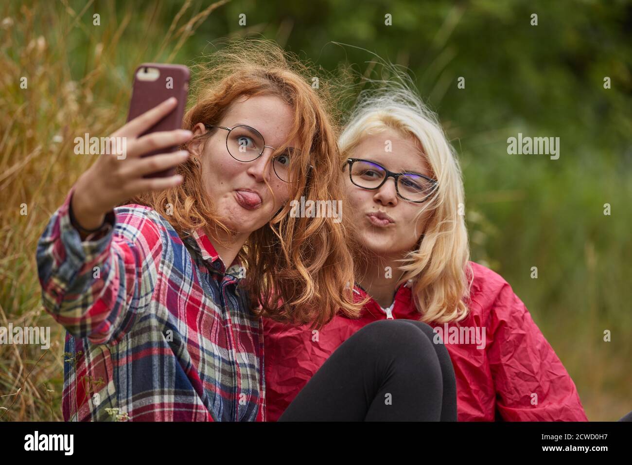 Girls making faces for selfie Stock Photo - Alamy