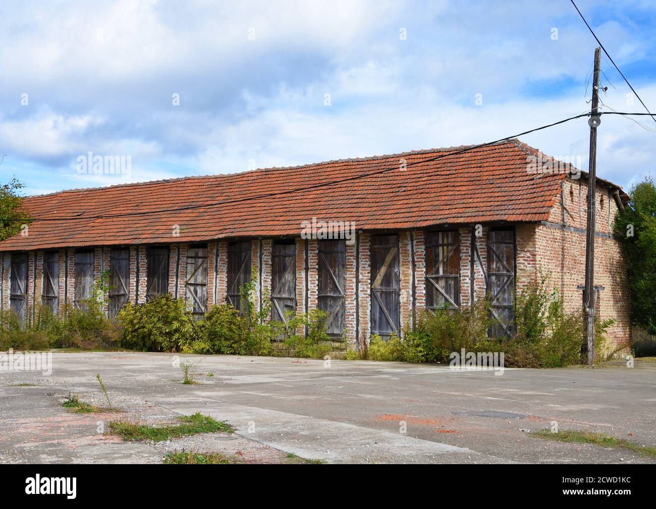 Old warehouse used for storing bricks and roof tiles Stock Photo - Alamy