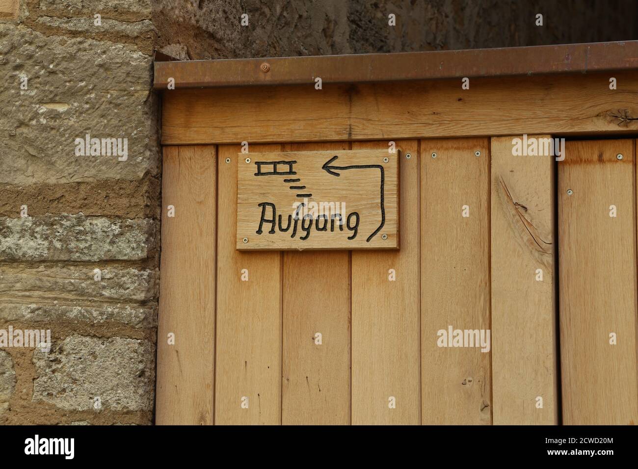 Plaque on a wooden gate, text in German: Stairs Stock Photo - Alamy