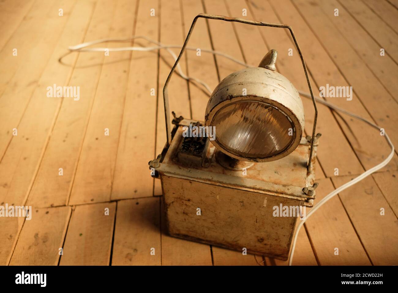 Old fashioned portable light on a wooden floor Stock Photo - Alamy