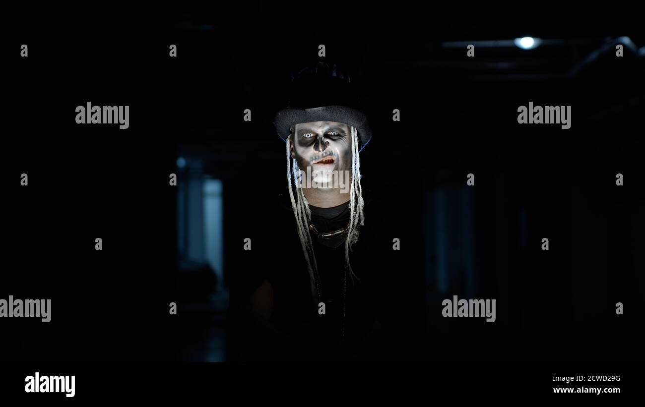 Frightening man in carnival skull Halloween makeup of skeleton against ...