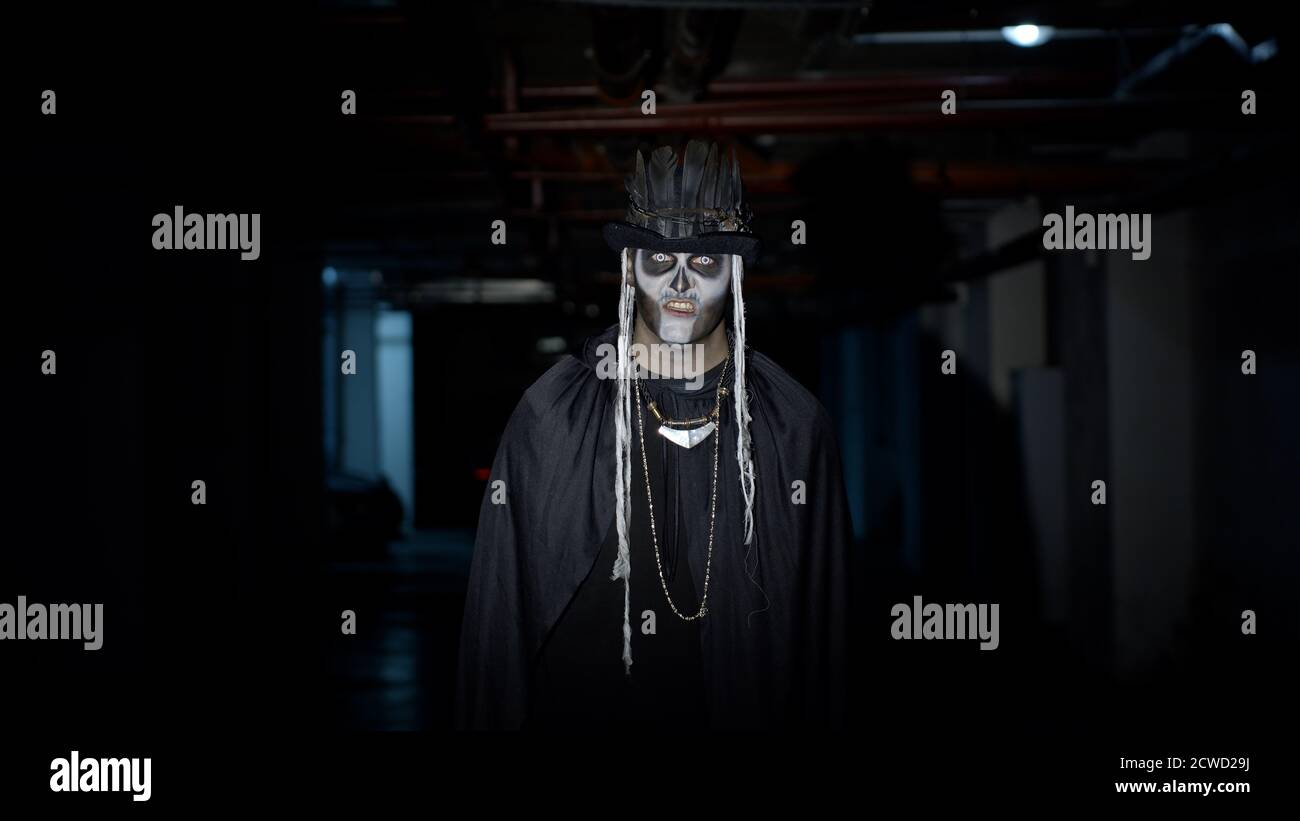 Scary man face in carnival skull Halloween makeup of skeleton against ...