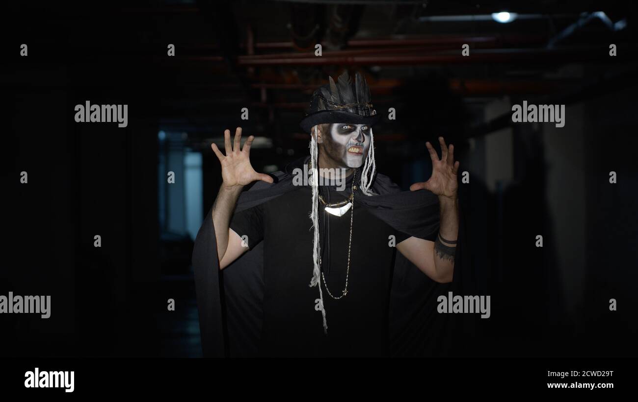 Scary man face in carnival skull Halloween makeup of skeleton against ...