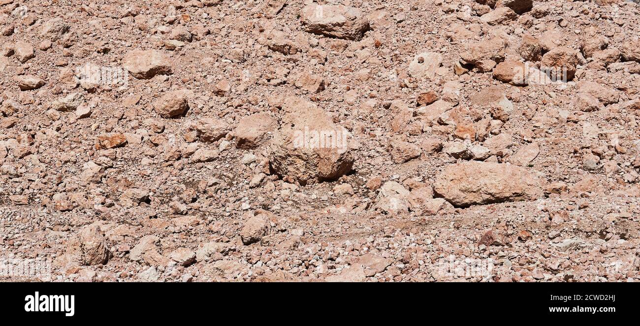 lifeless bed of a melted glacier of reddish stones, reminiscent of a ...