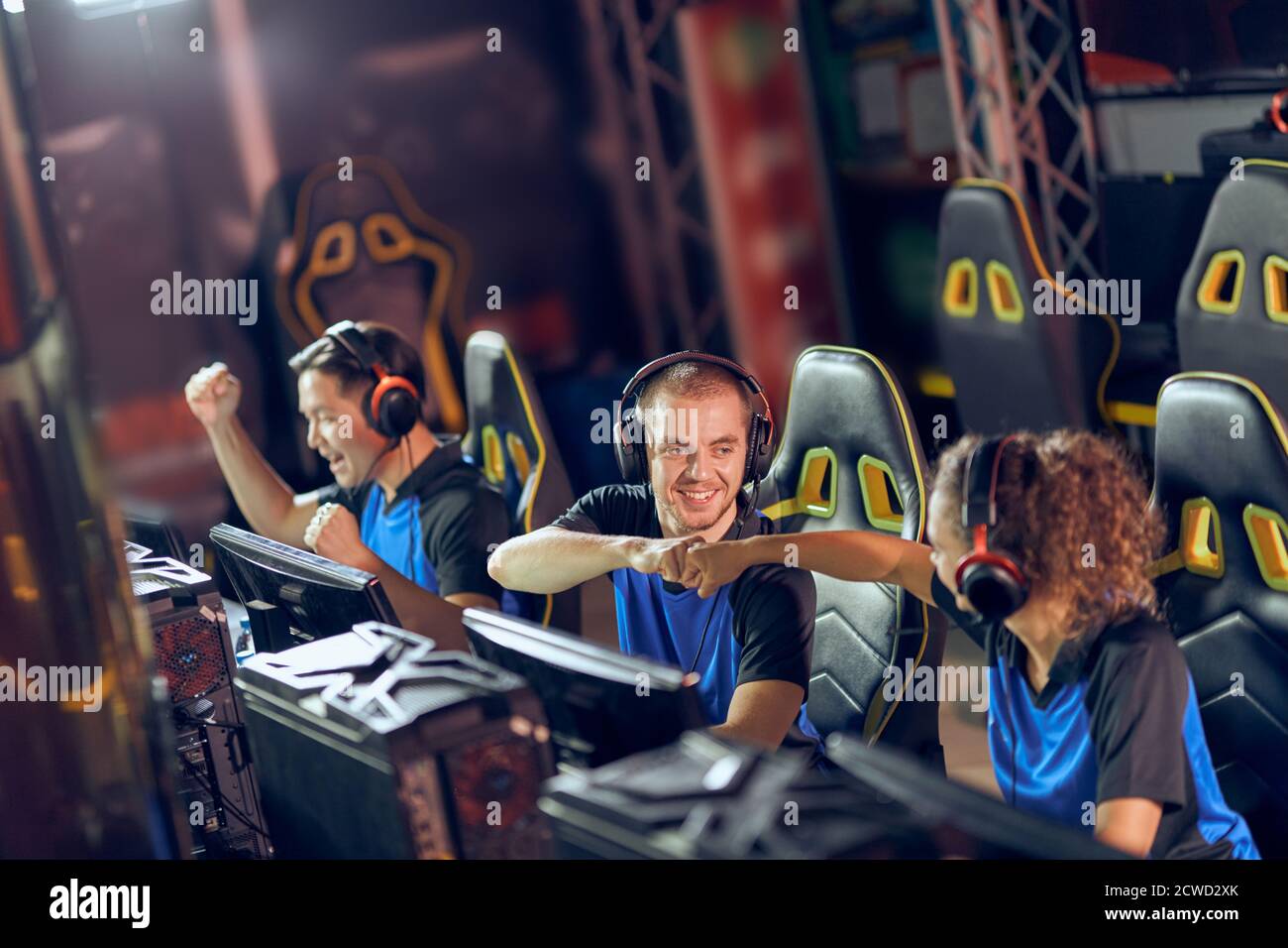 Professional cyber sport gamers giving fist bump and celebrating ...