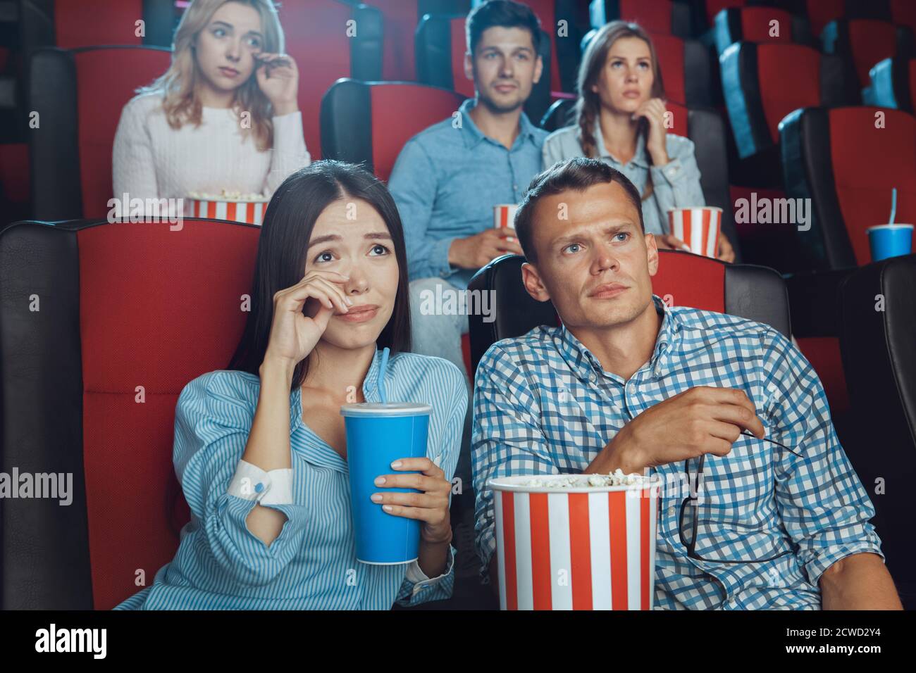 Young people friends in the cinema watching movie Stock Photo - Alamy
