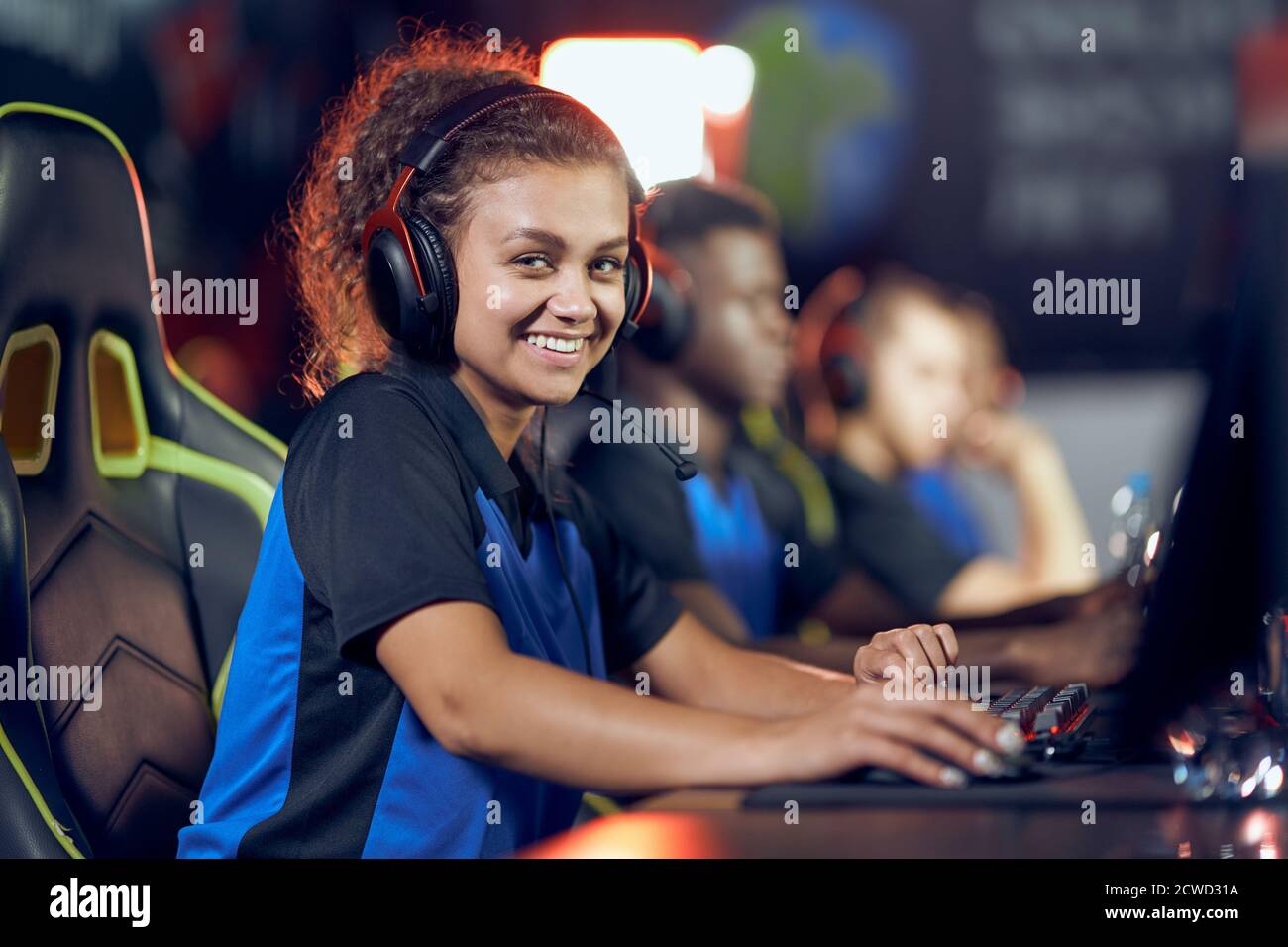 Professional gamer. Side view of a happy mixed race teenage girl ...