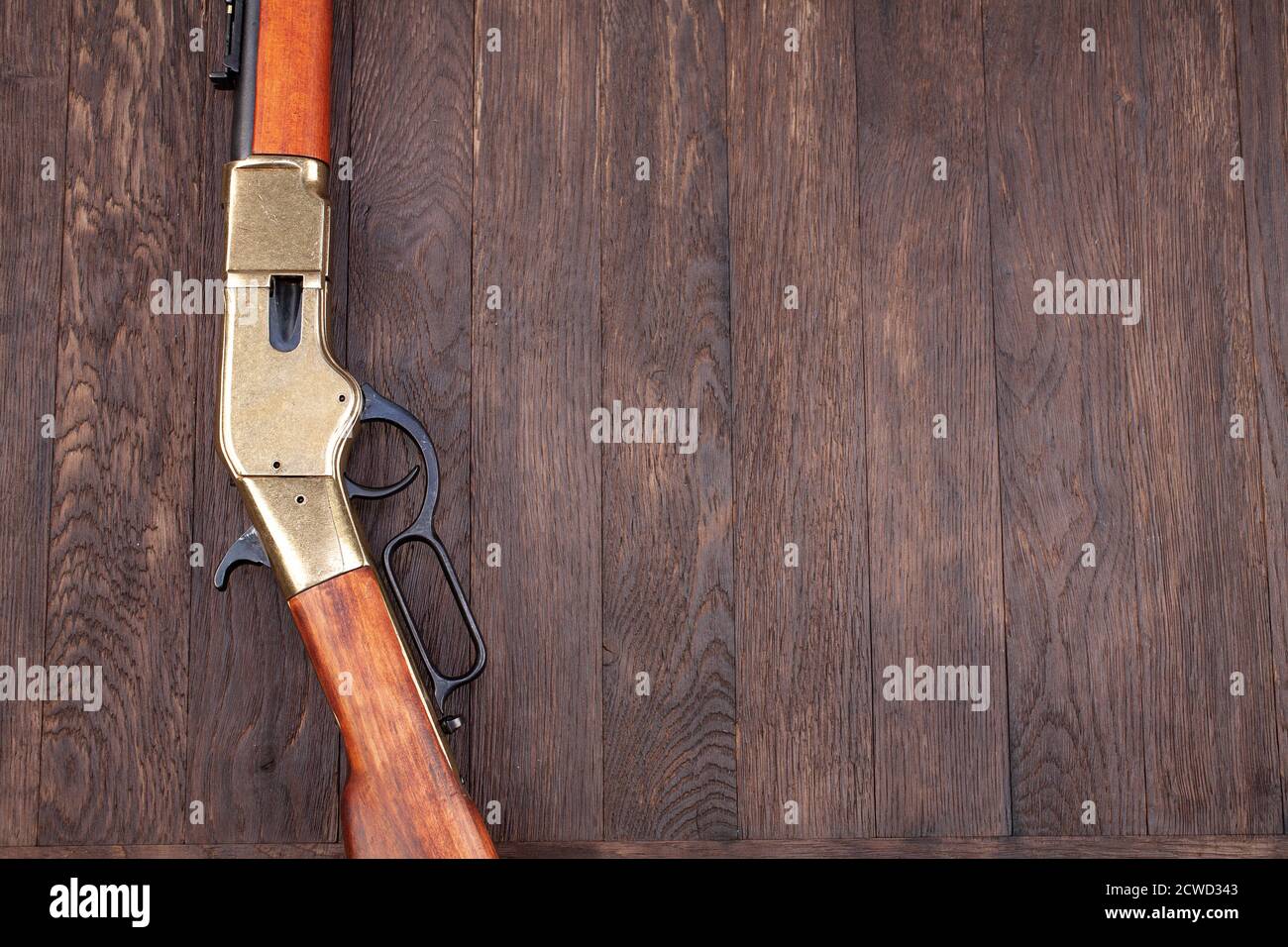 Old west gun - lever-action repeating rifles with ammunition on wooden ...