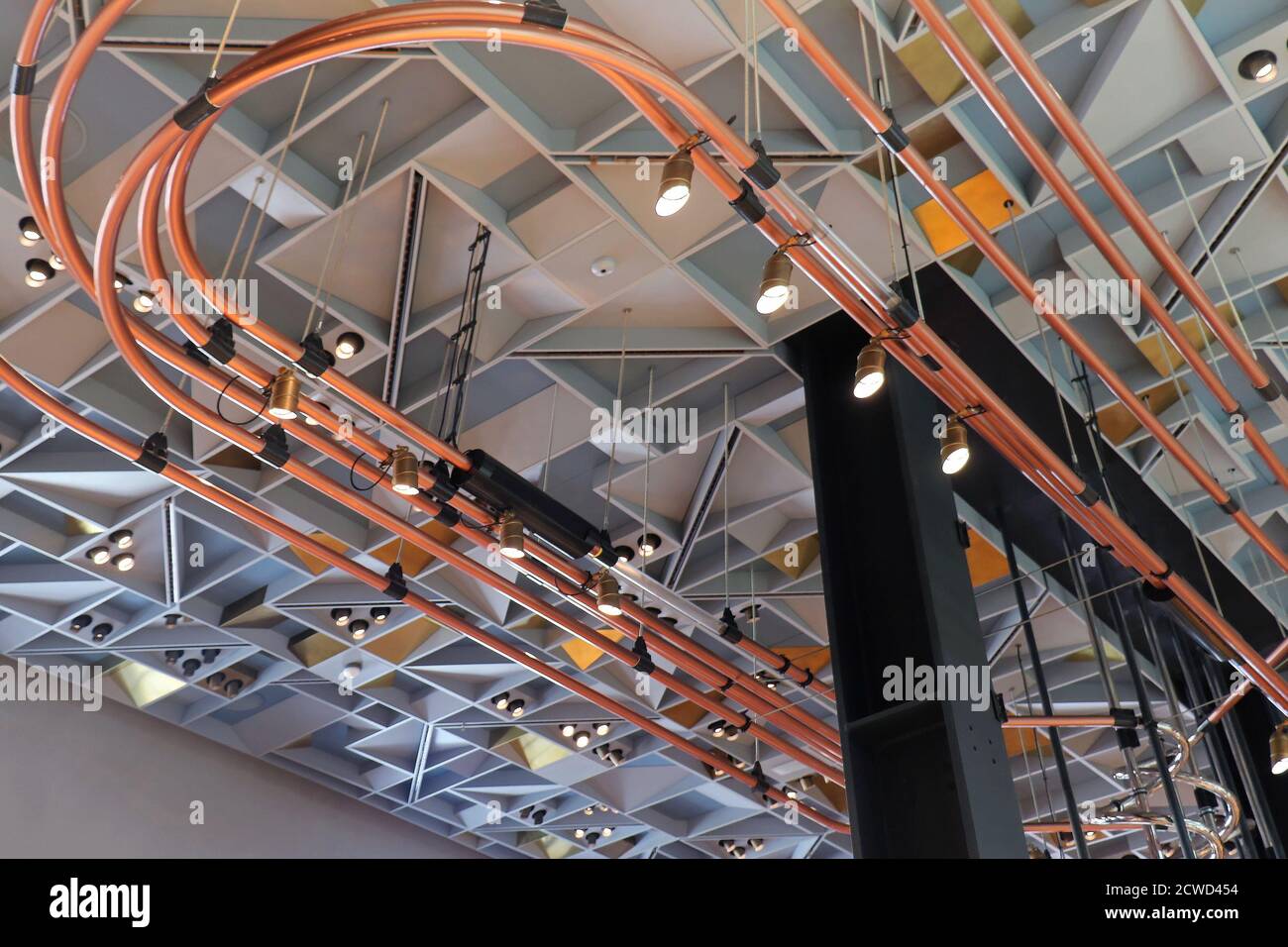 Colorful metal installation pipes on interior ceiling Stock Photo - Alamy