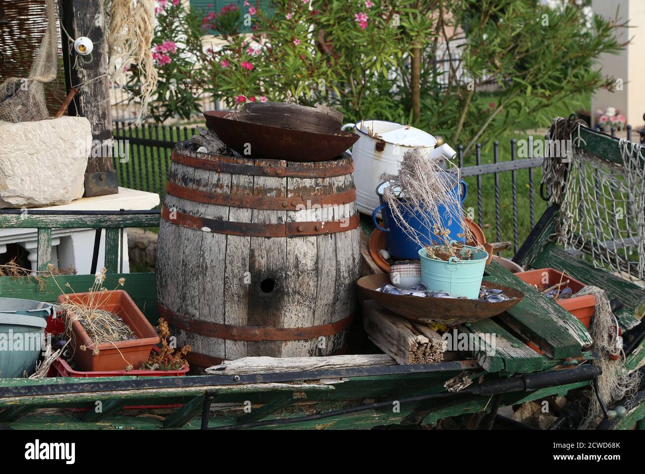 Old barrel dishes and other junk used as decoration Stock Photo - Alamy