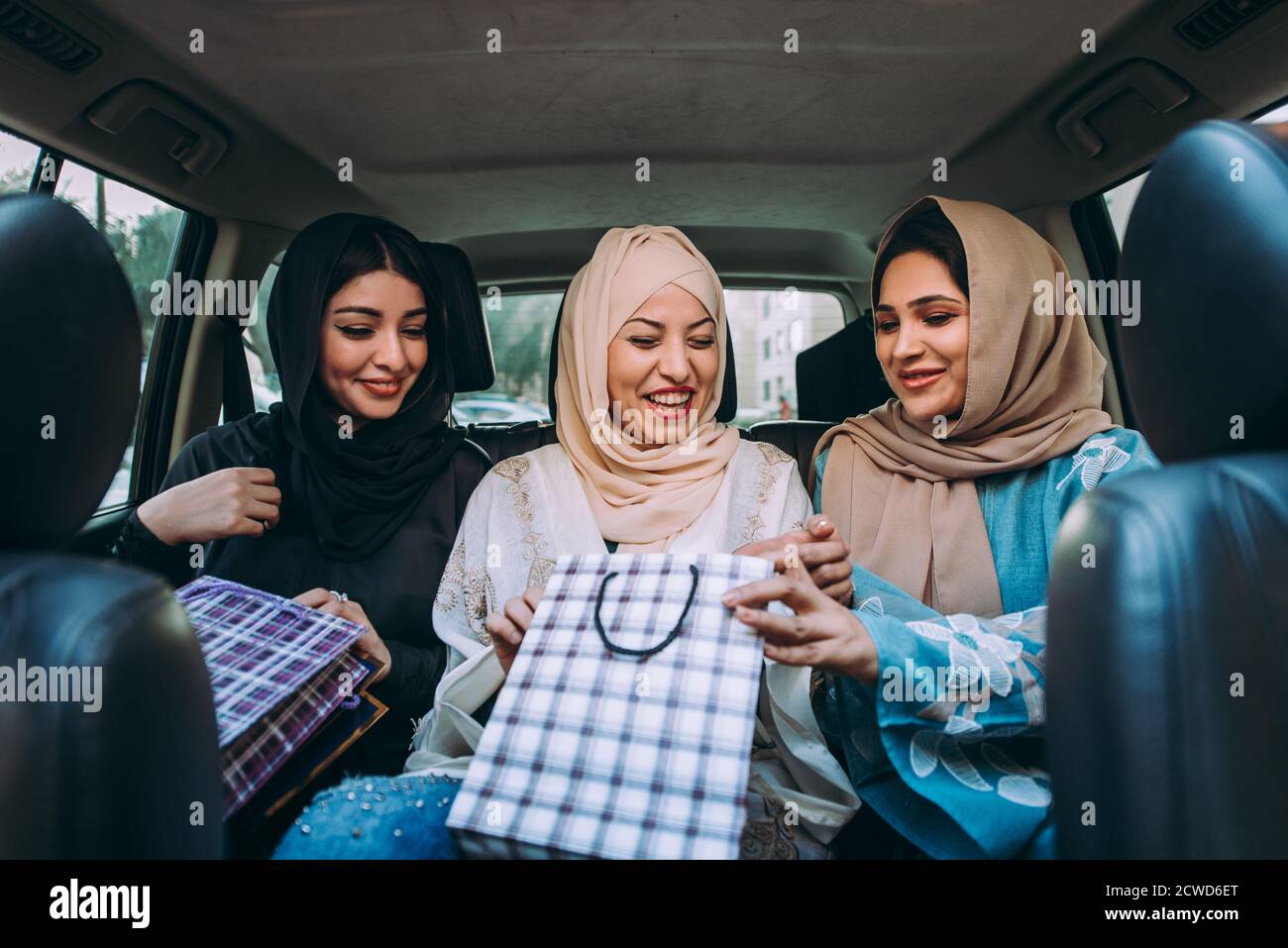Three women friends going out in Dubai. Girls wearing the united arab ...