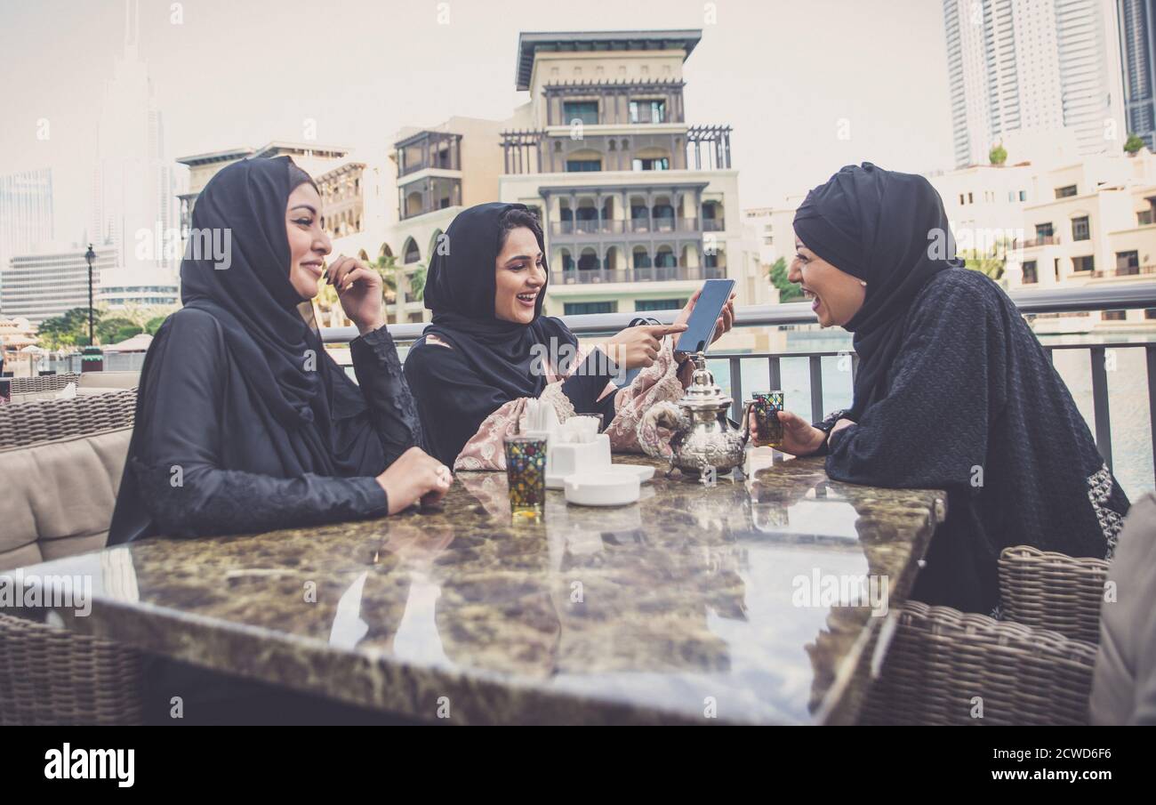Three women friends going out in Dubai. Girls wearing the united arab ...