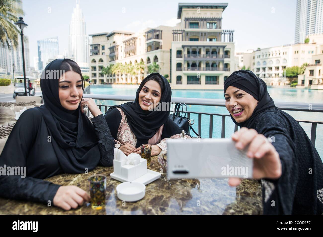 Three women friends going out in Dubai. Girls wearing the united arab ...