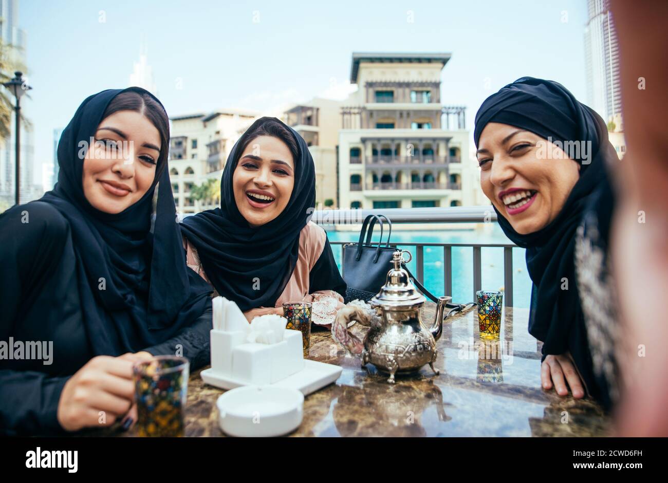 Three women friends going out in Dubai. Girls wearing the united arab ...