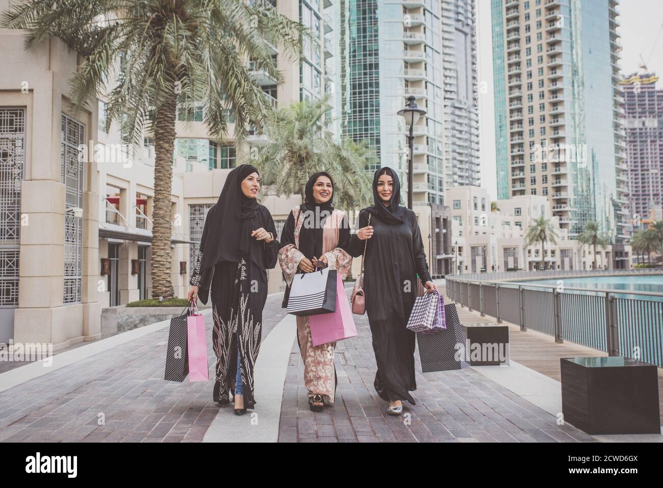 Three women friends going out in Dubai. Girls wearing the united arab ...