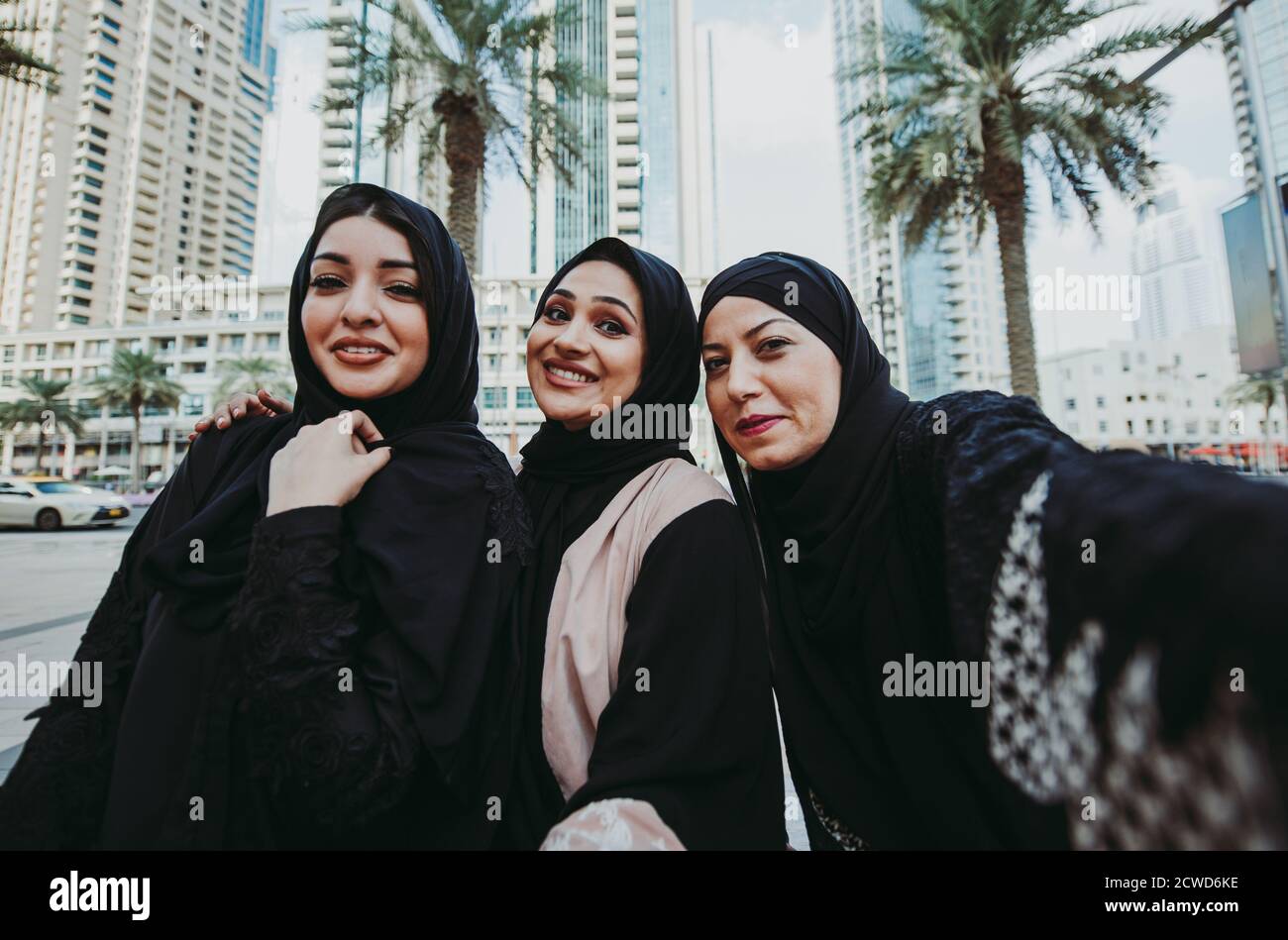 Three women friends going out in Dubai. Girls wearing the united arab ...