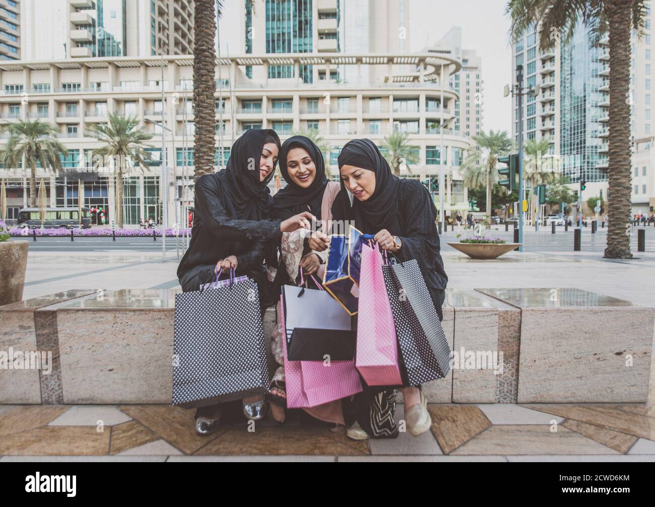Three women friends going out in Dubai. Girls wearing the united arab ...