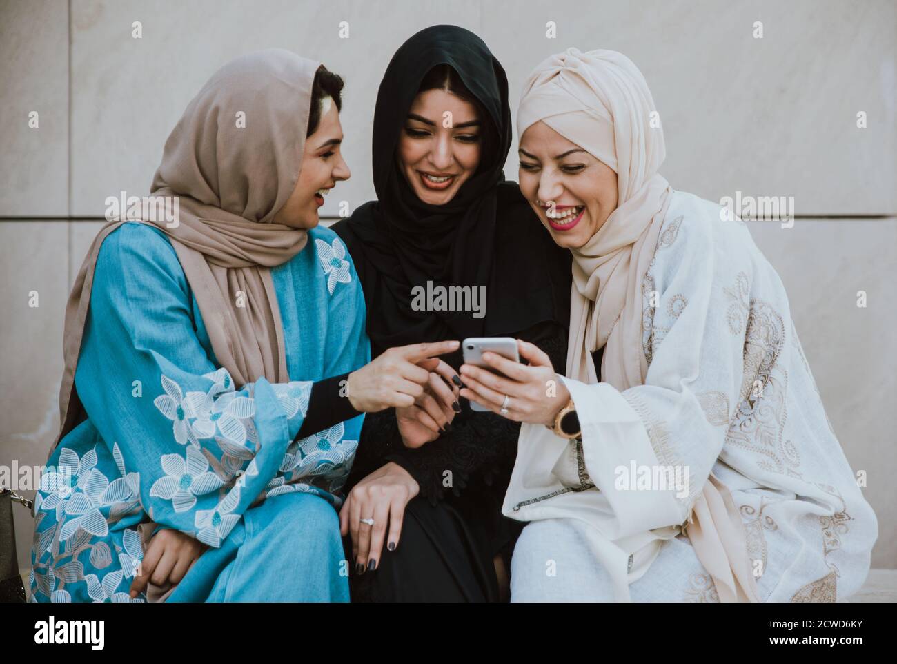 Three women friends going out in Dubai. Girls wearing the united arab ...
