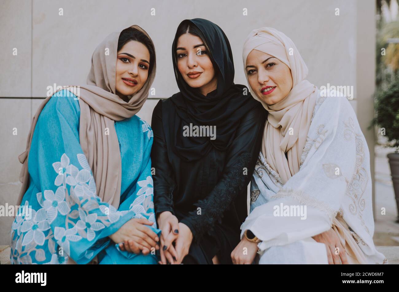 Three women friends going out in Dubai. Girls wearing the united arab ...