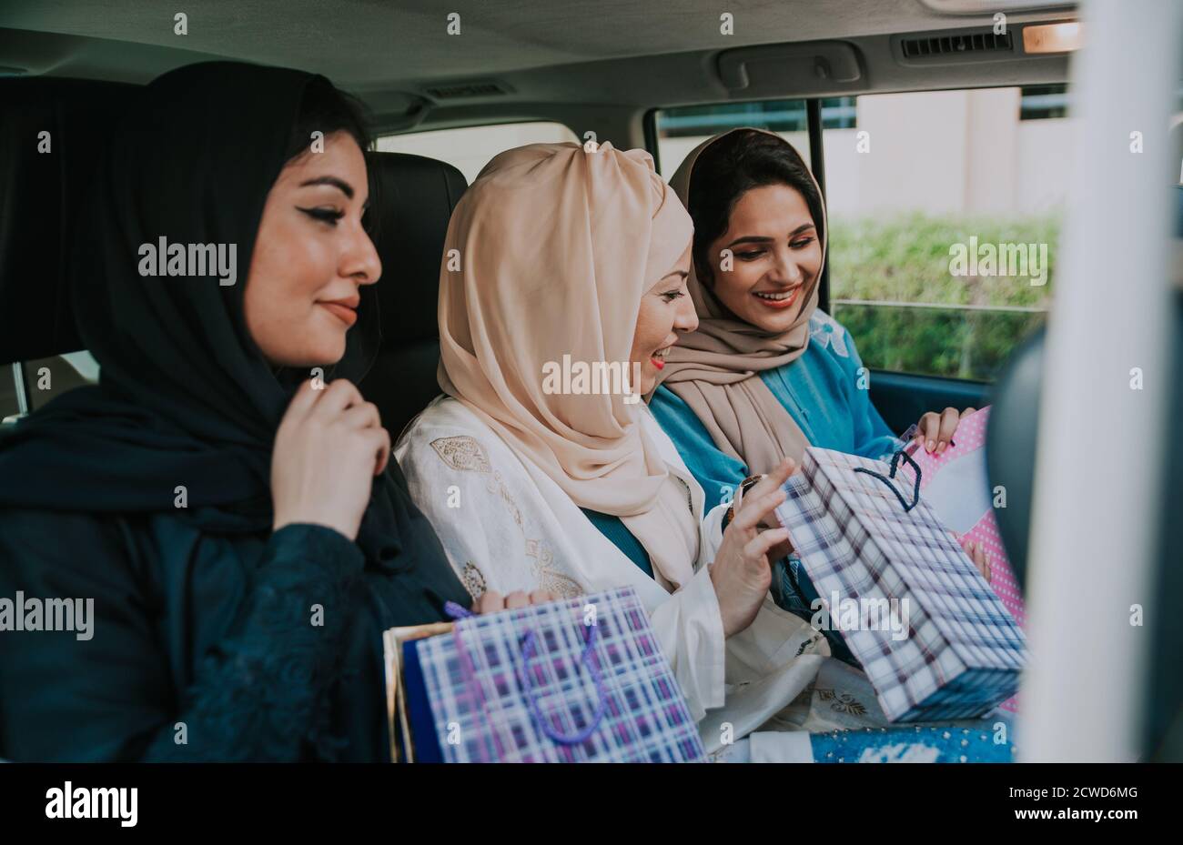 Three women friends going out in Dubai. Girls wearing the united arab ...