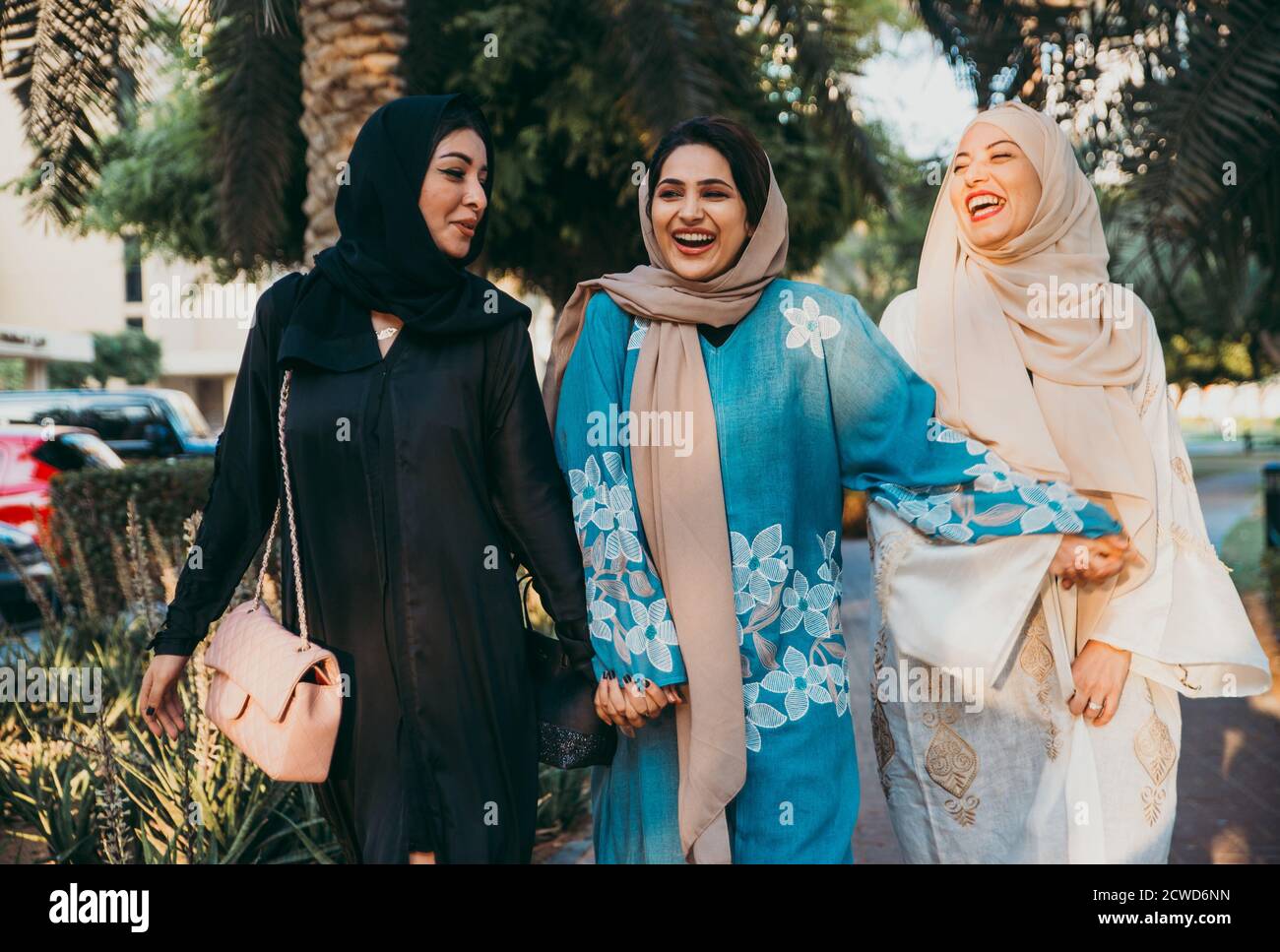 Three women friends going out in Dubai. Girls wearing the united arab ...