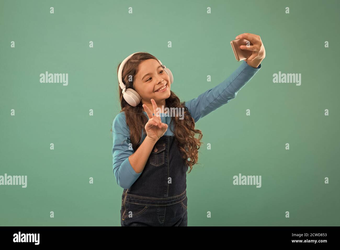 Hello world. Video call. Small girl child with smartphone. Small girl ...