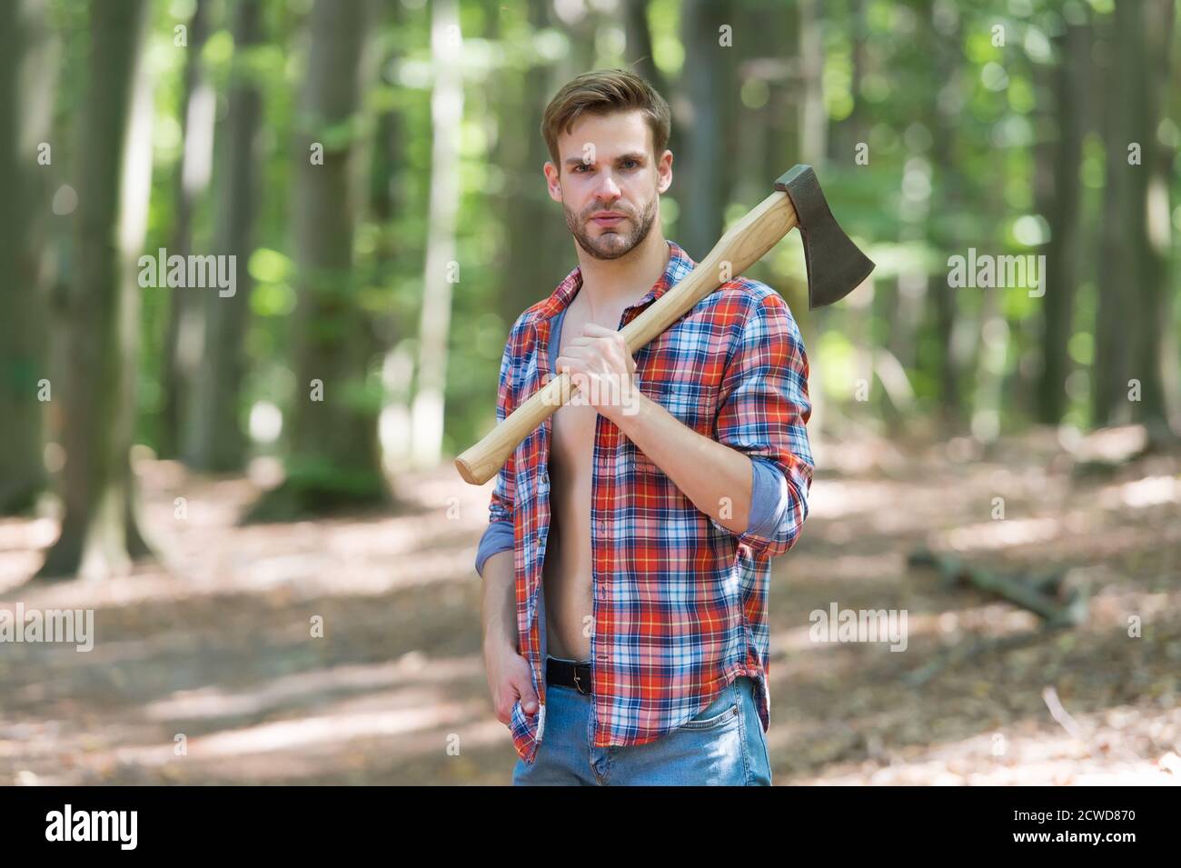 Man walking into forest with axe hi-res stock photography and images ...