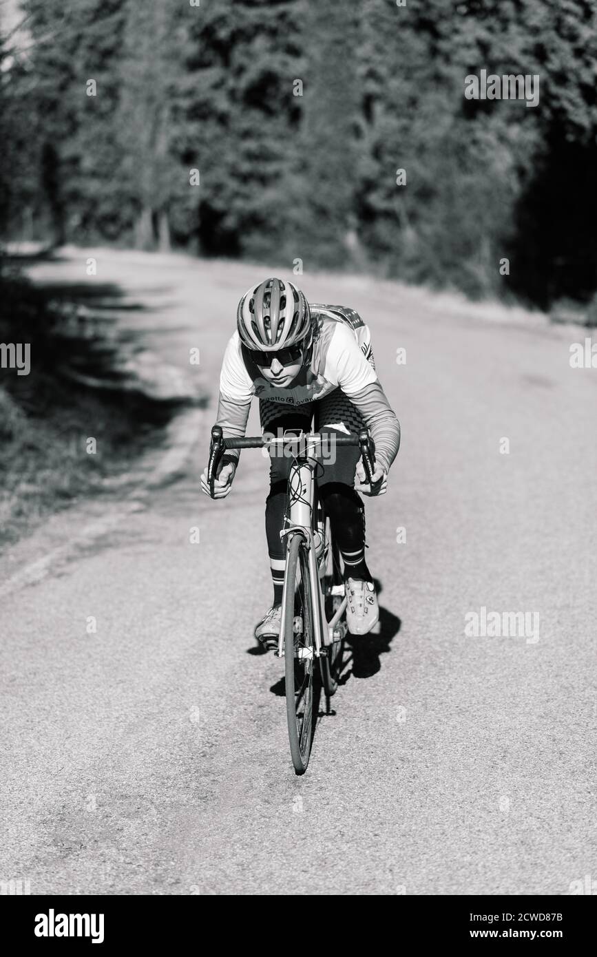 Professional cyclist riding racing bike in competition on open road ...