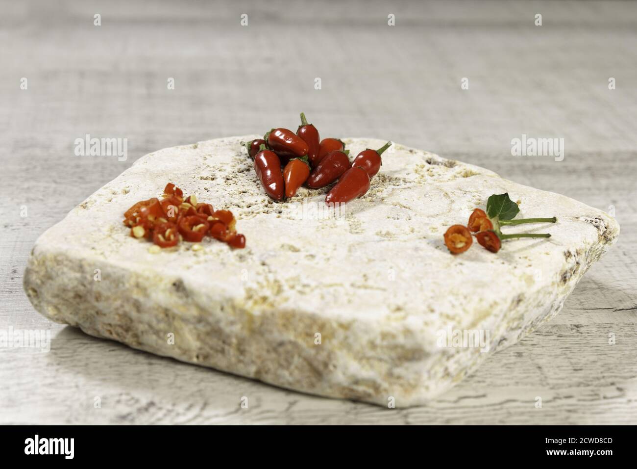 Closeup shot of cut chili pepper on a white stone Stock Photo - Alamy
