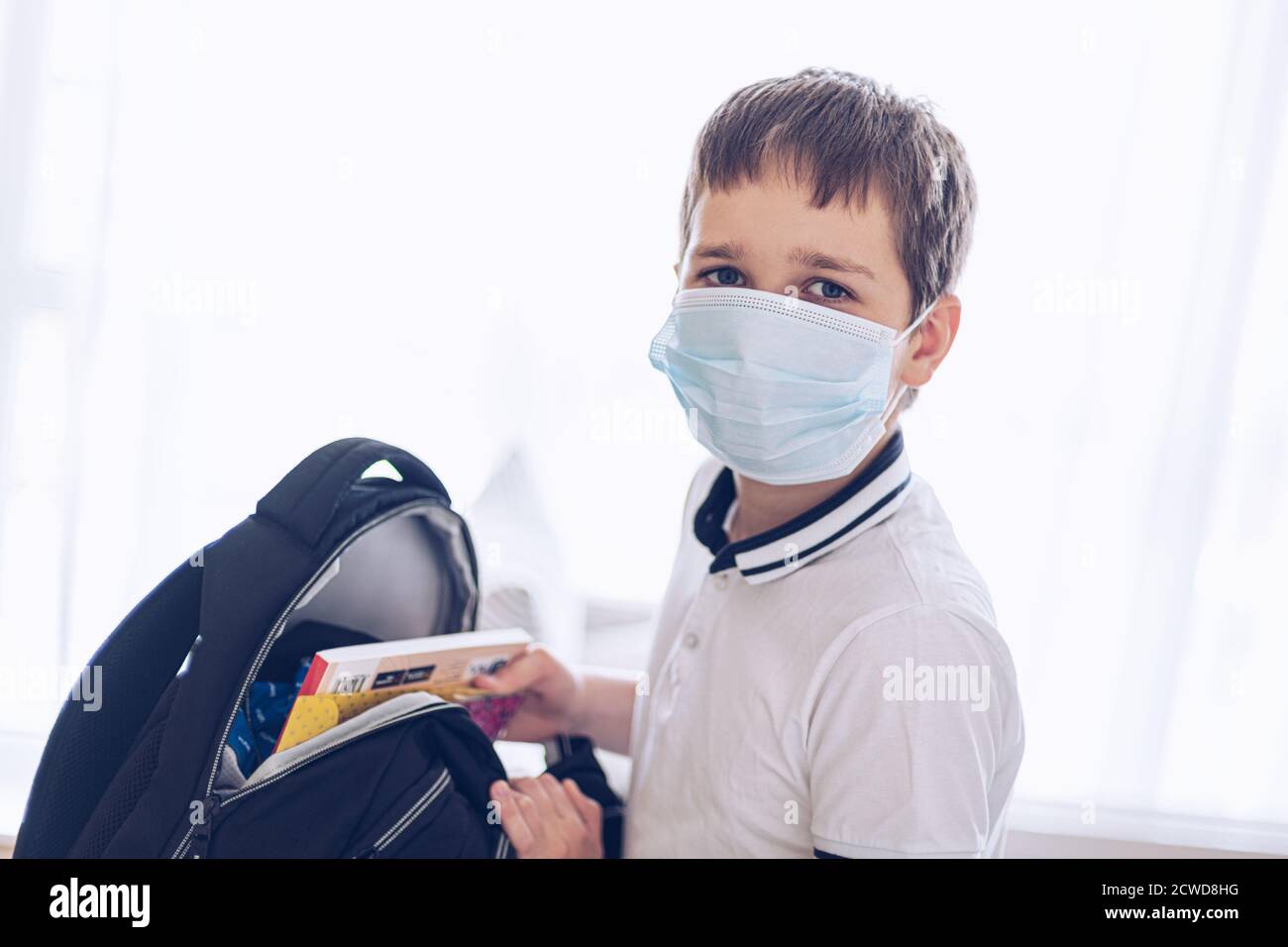 Child boy packing his school backpack at home Stock Photo - Alamy