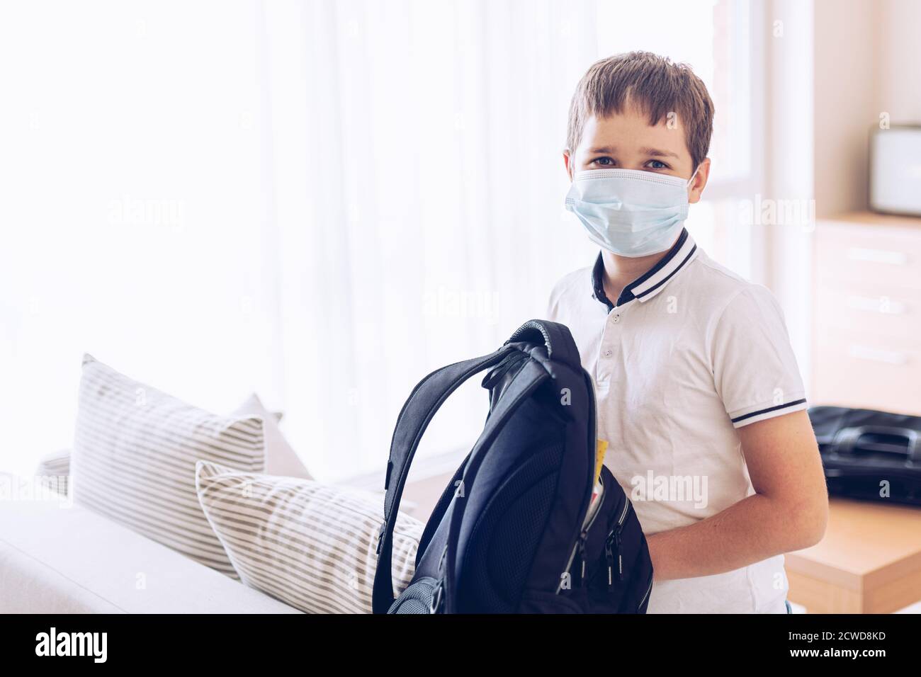 Child boy packing his school backpack at home Stock Photo - Alamy