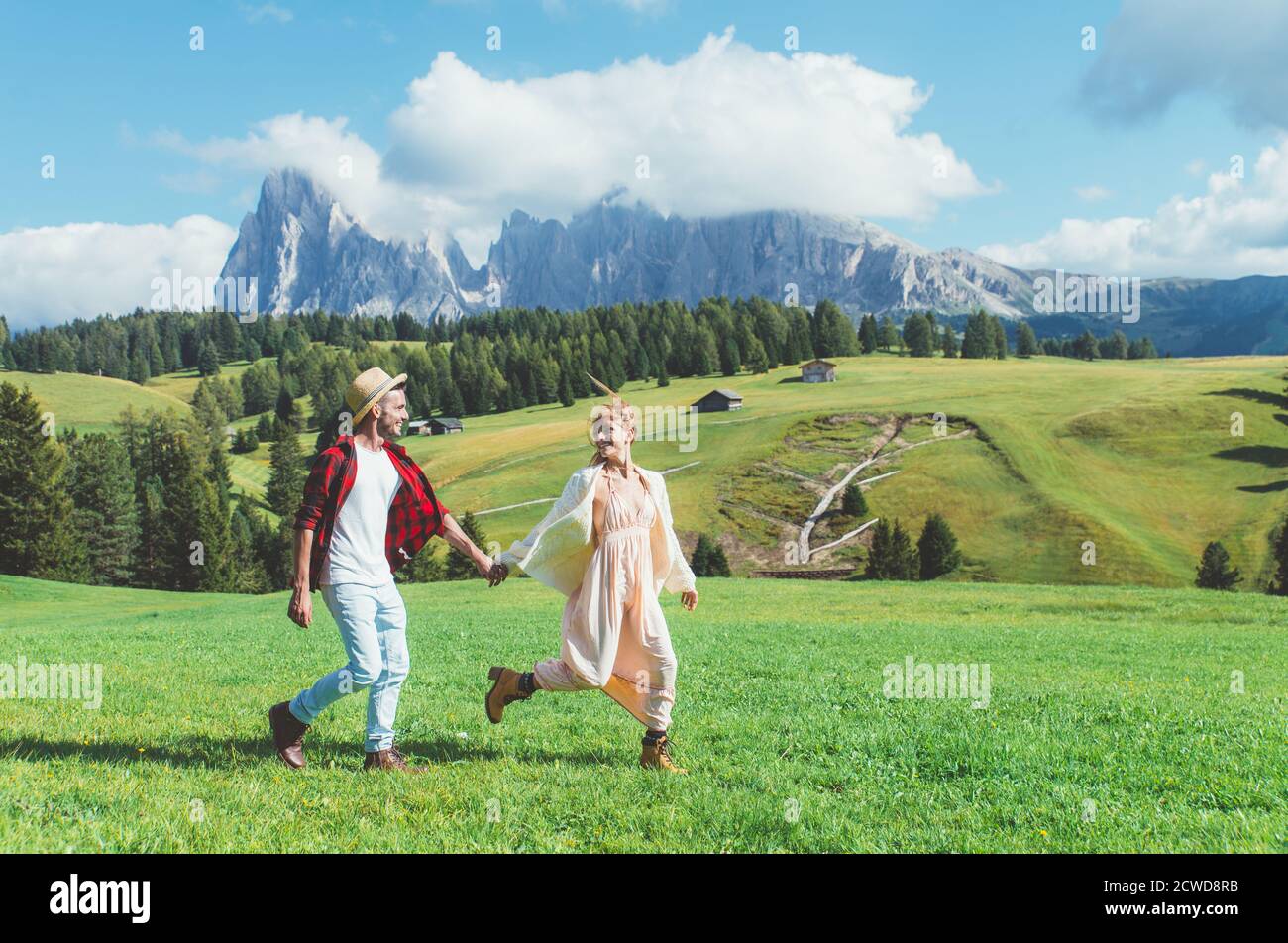 Happy couple on vacation on the italian dolomites mountains. Young man ...