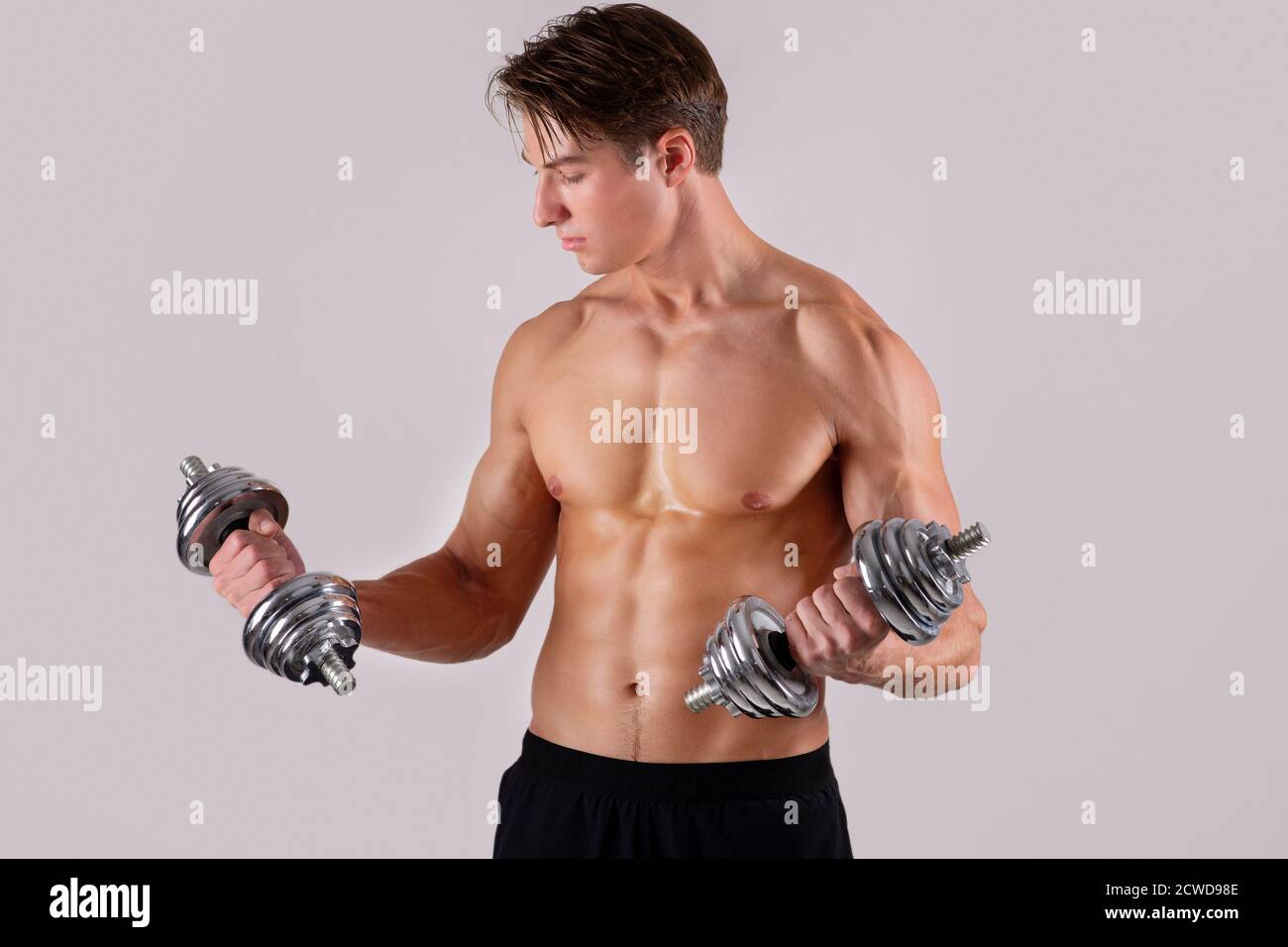 Powerful handsome young man with bare torso and prominent muscles ...