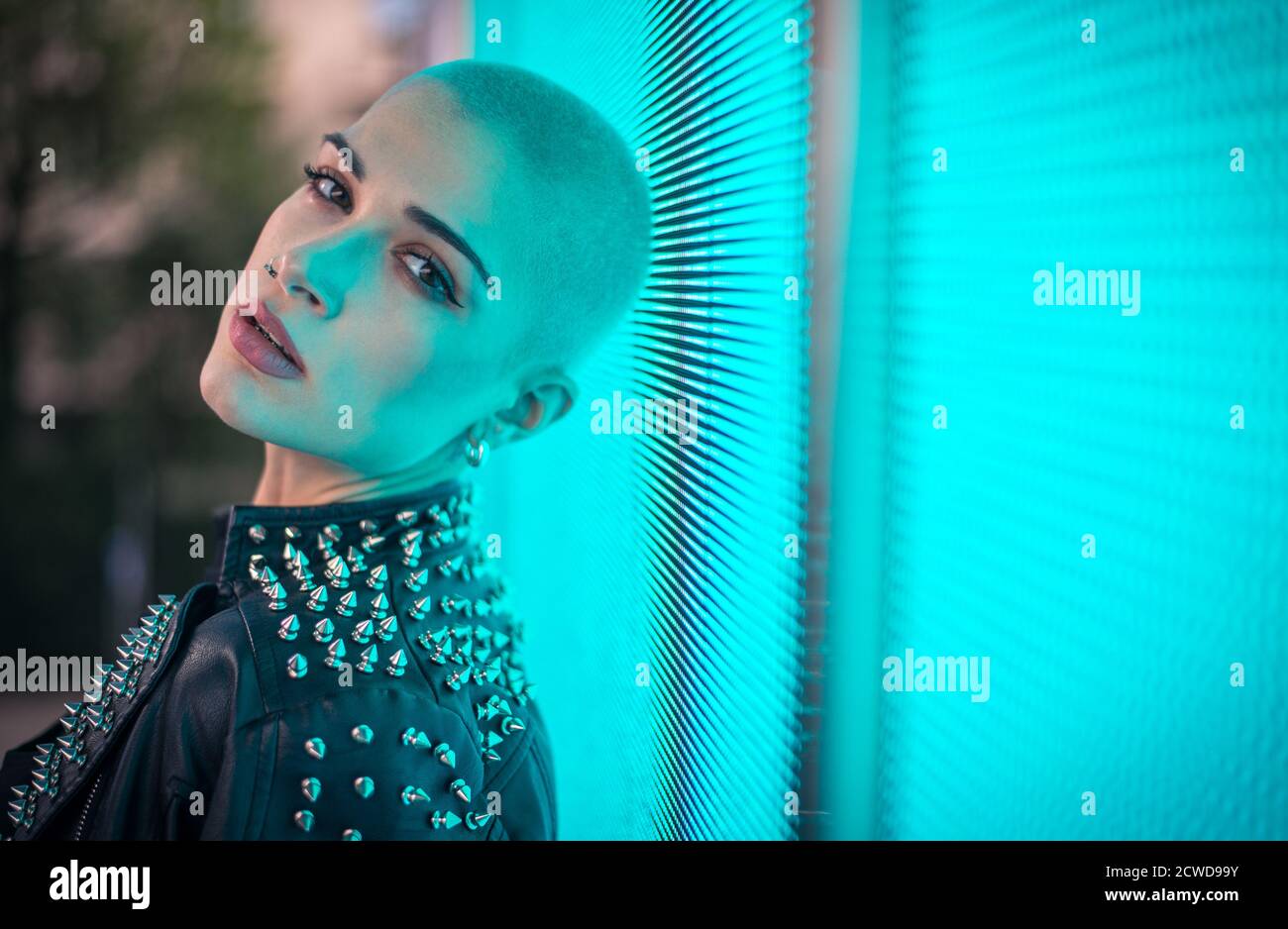 Image Of A Beautiful Young Woman Posing Against A Led Panel Shaved