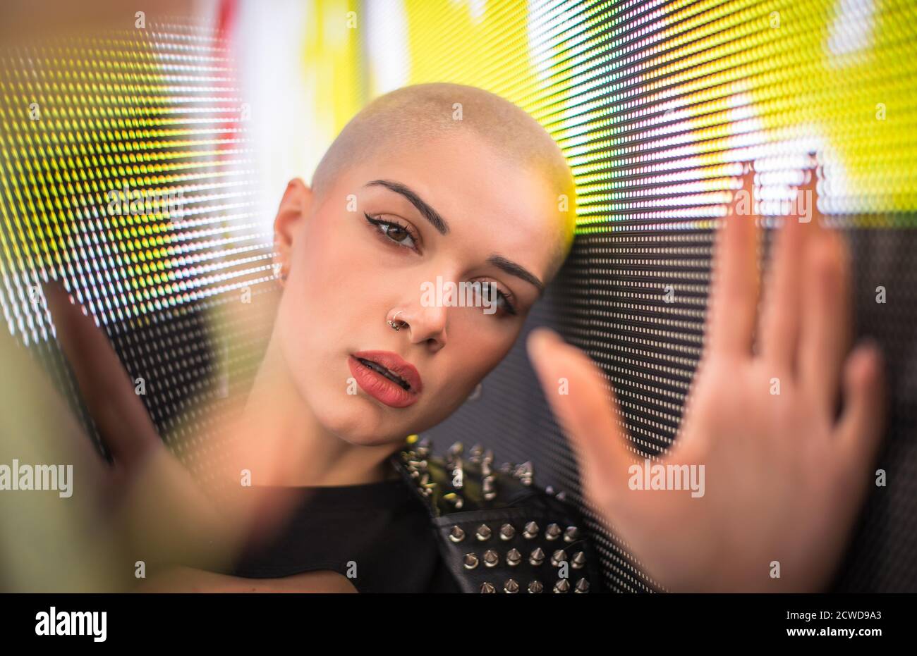 Image Of A Beautiful Young Woman Posing Against A Led Panel Shaved