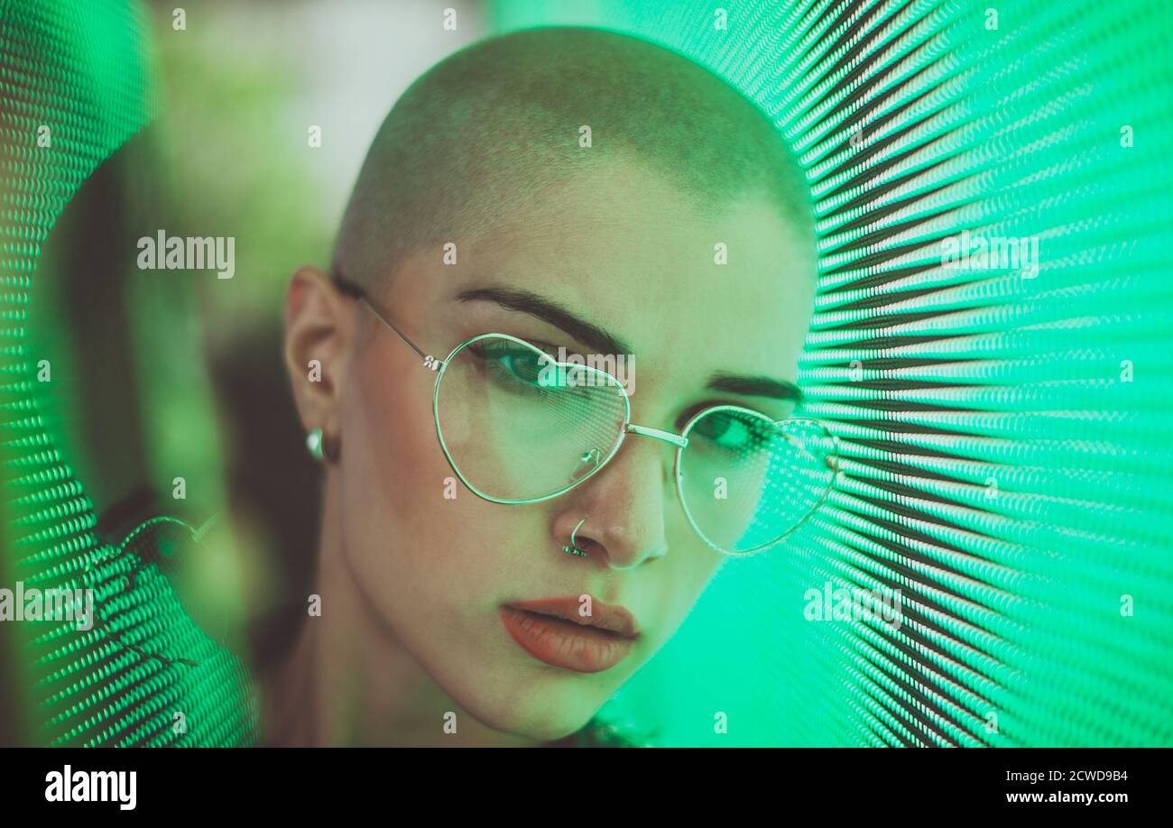 Image Of A Beautiful Young Woman Posing Against A Led Panel Shaved