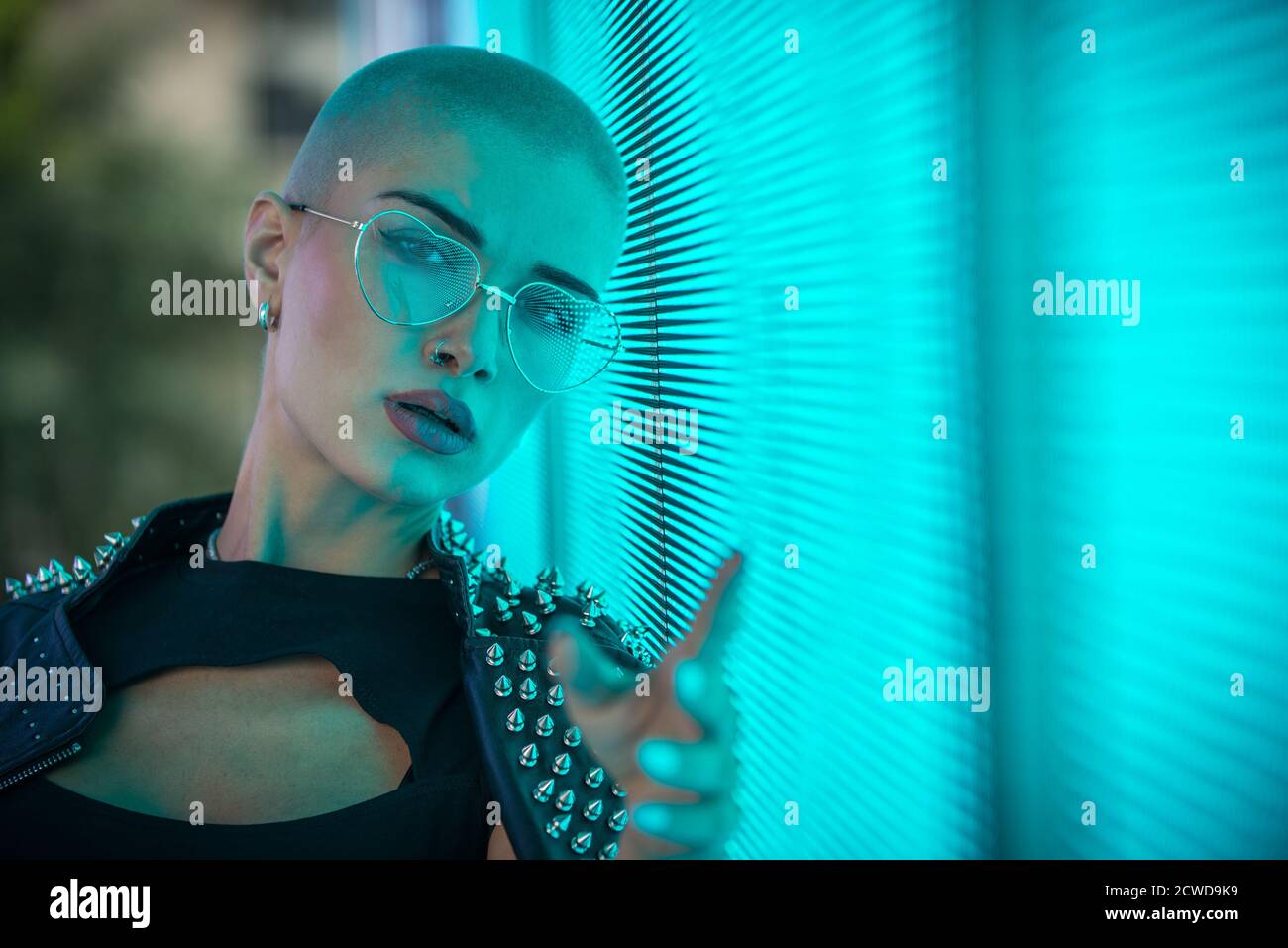 Image Of A Beautiful Young Woman Posing Against A Led Panel Shaved