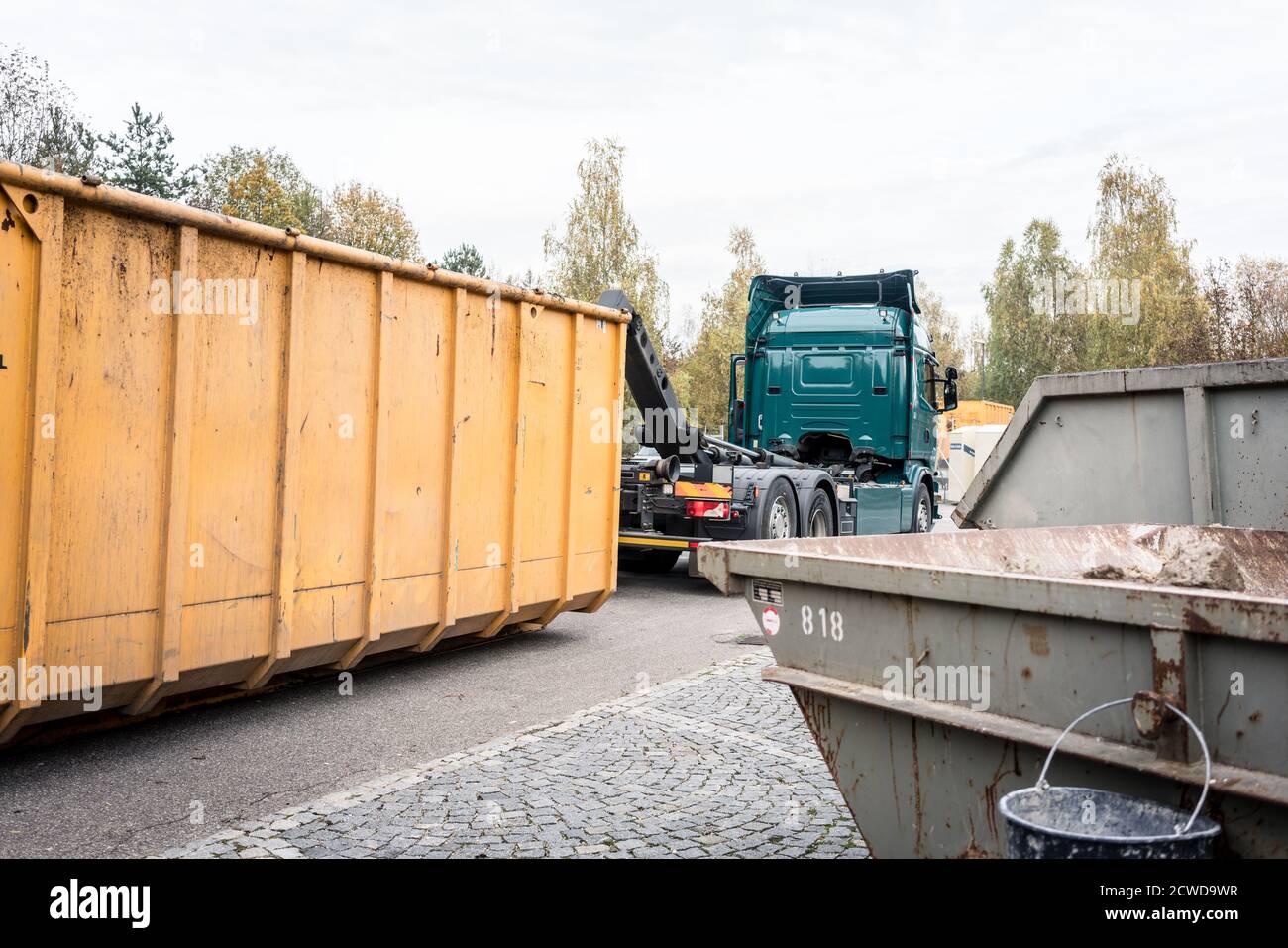 Truck loading container with waste on recycling center Stock Photo - Alamy