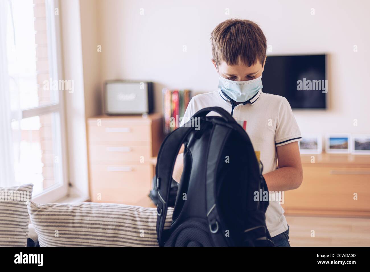 Child boy packing his school backpack at home Stock Photo - Alamy