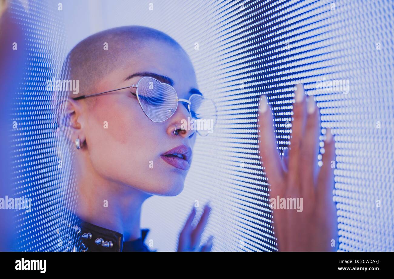 Image Of A Beautiful Young Woman Posing Against A Led Panel Shaved