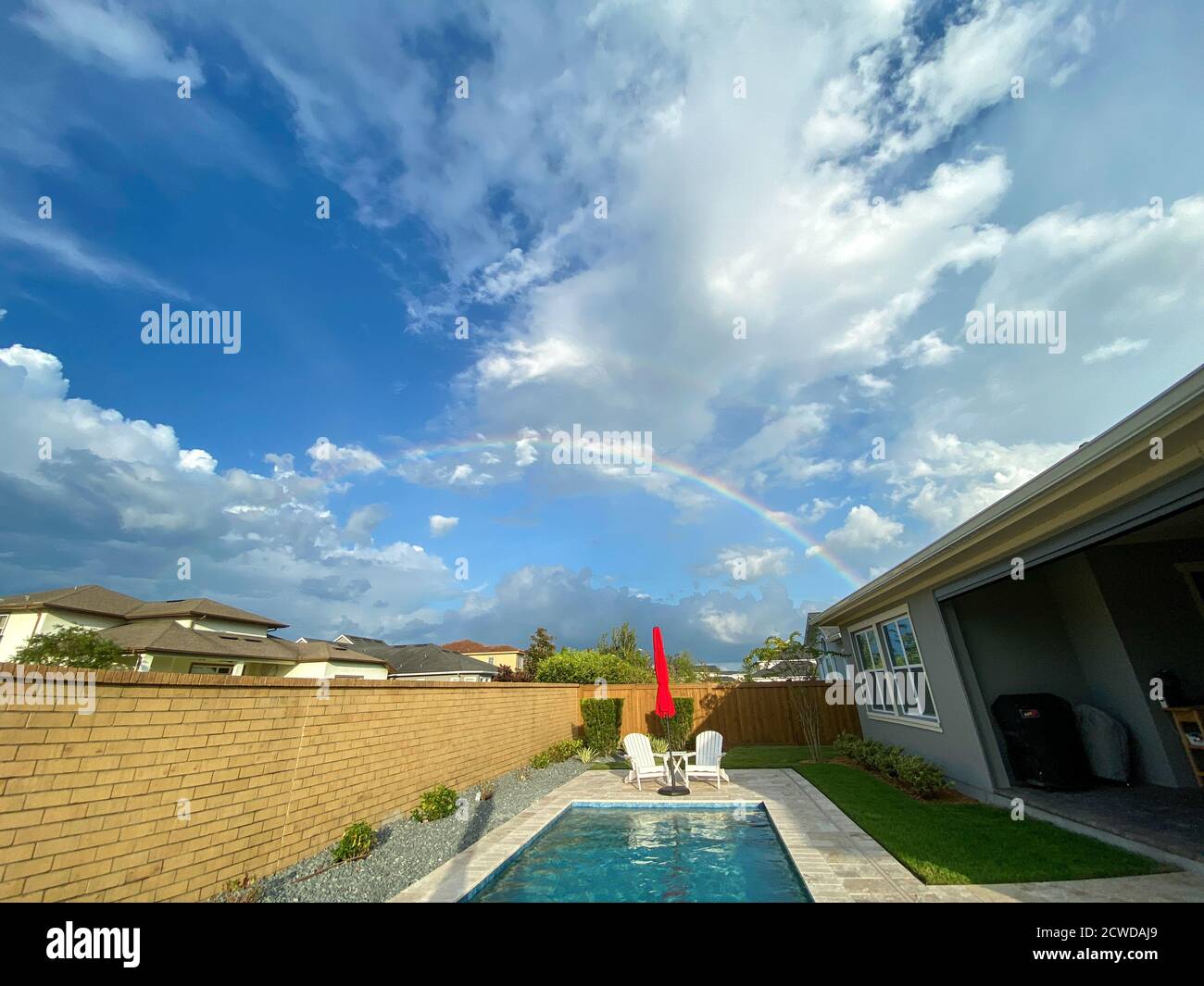 A rainbow in a backyard with a pool in Orlando, Florida Stock Photo - Alamy