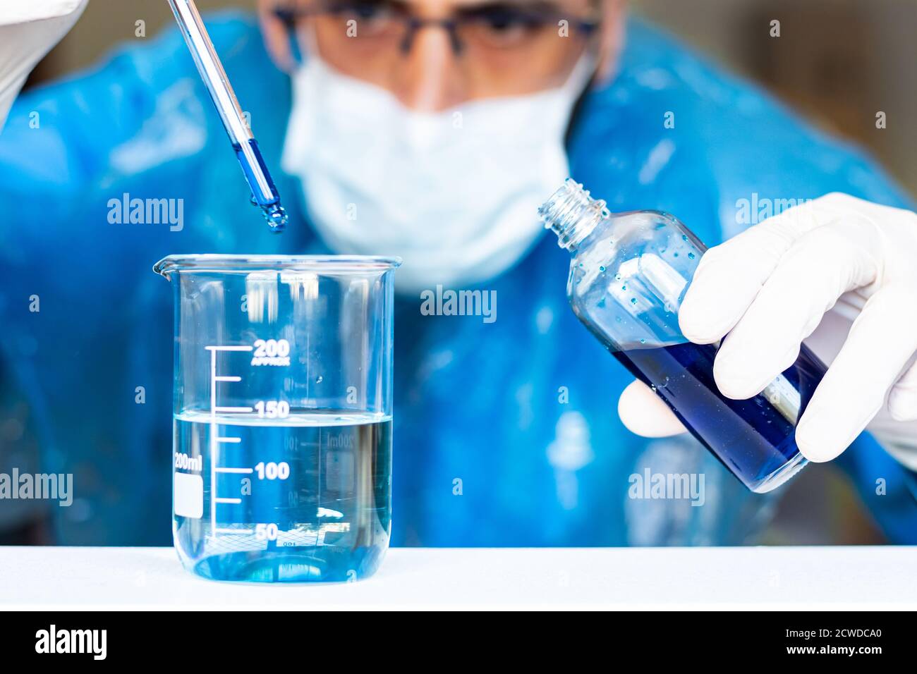 Close-up of a professional male scientist in gloves making experiment ...