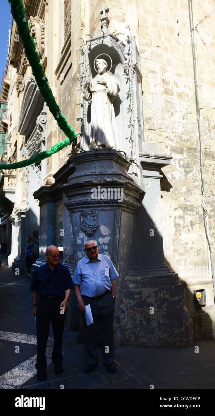 Maltese men walking through the old streets of Valletta, Malta Stock ...