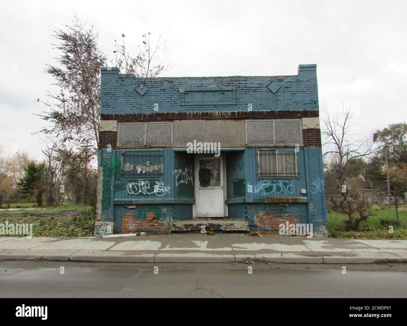 Abandoned brick storefront painted blue in Detroit’s Delray ...