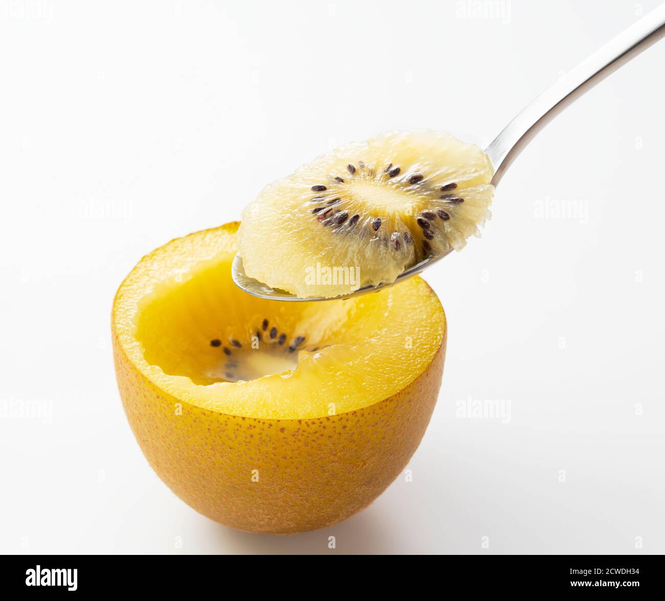 Eating Golden Kiwi with a spoon Stock Photo - Alamy